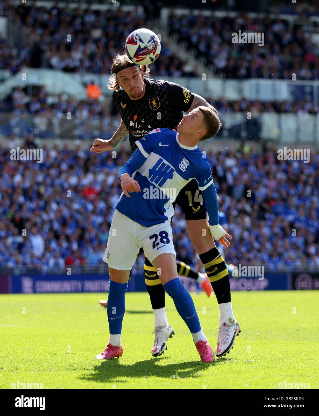 Birmingham City's Jay Stansfield (front) and Mansfield Town's Aden ...