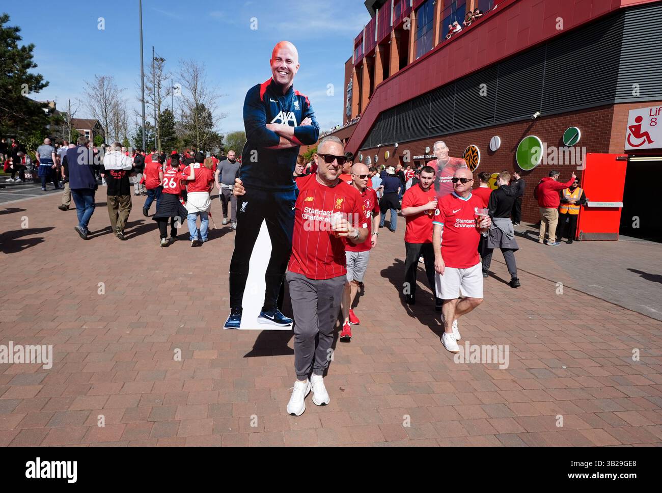 A Liverpool fan outside the ground with a cardboard cut out of manager ...