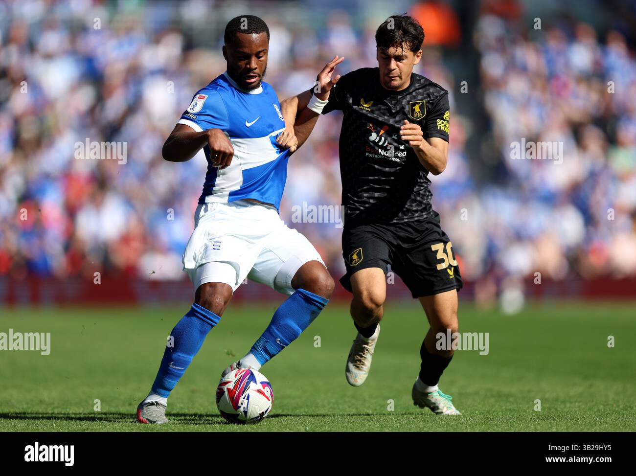 Birmingham City's Ethan Laird (left) and Mansfield Town's Caylan ...