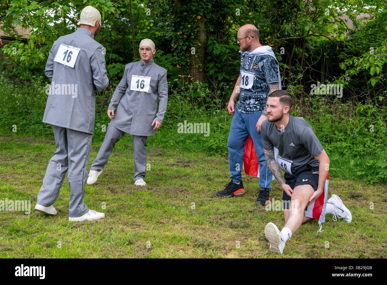London, UK. 27 April 2025. Costumed participants stretch ahead of the ...