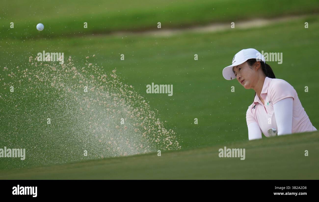 Yu Liu, of China, hits out of a bunker on the eighth hole during the ...