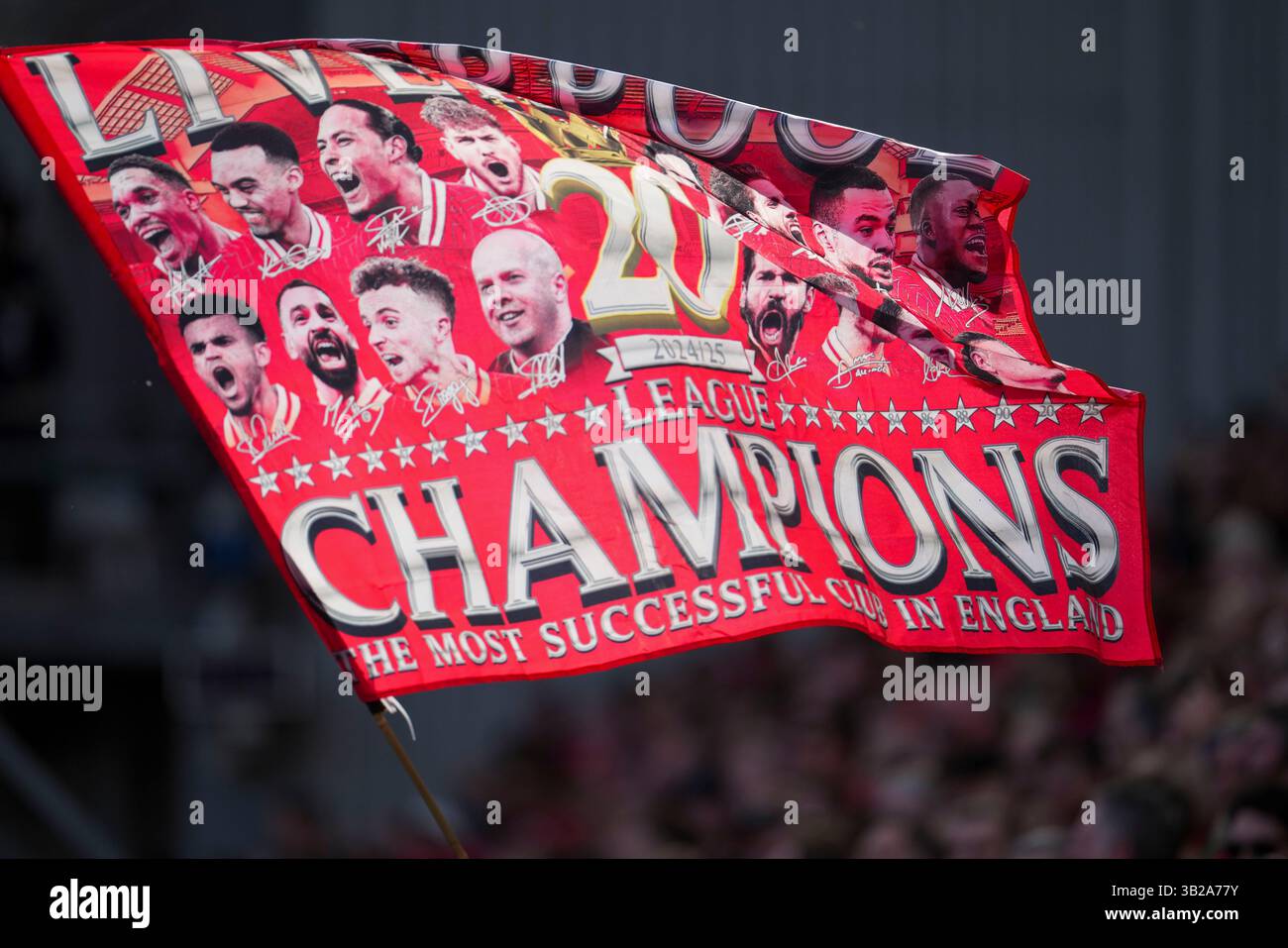 A Liverpool supporter waves a flag before the English Premier League ...
