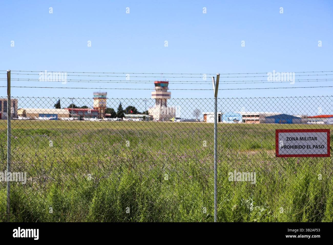 Translation: "Military zone, no entry." Barbed wire fence preventing ...
