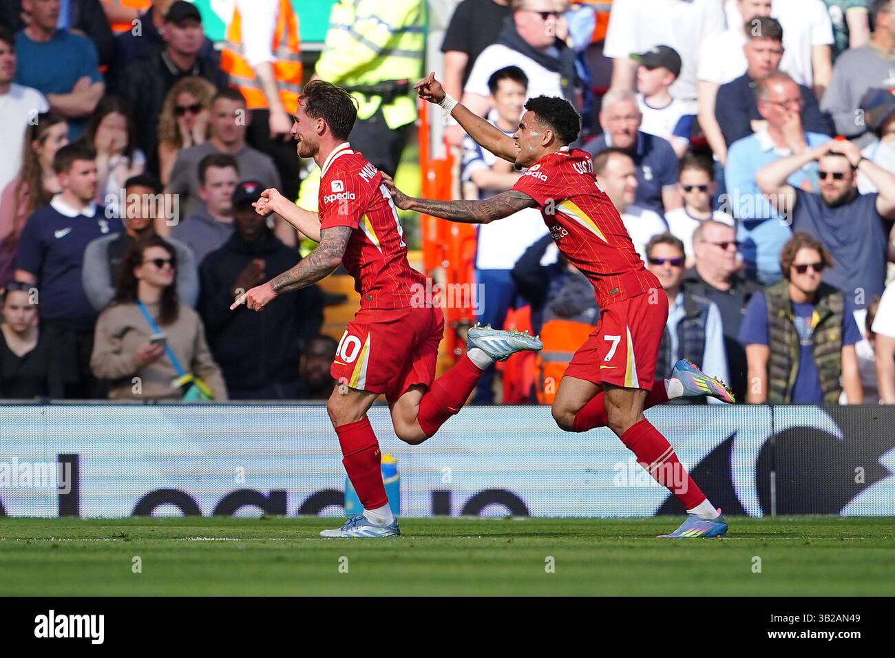 Liverpool's Alexis Mac Allister (left) celebrates scoring their side's ...