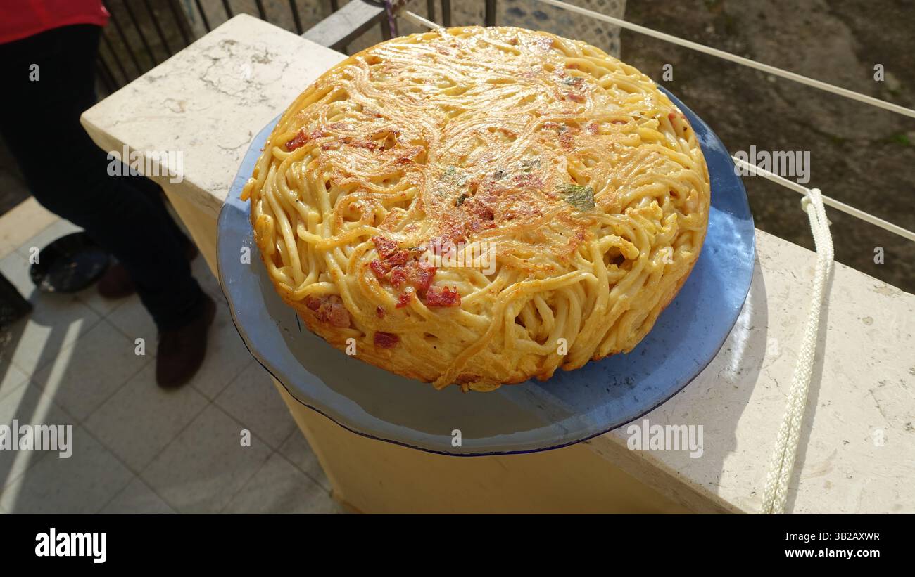 A traditional Neapolitan spaghetti omelette, freshly cooked and ready ...