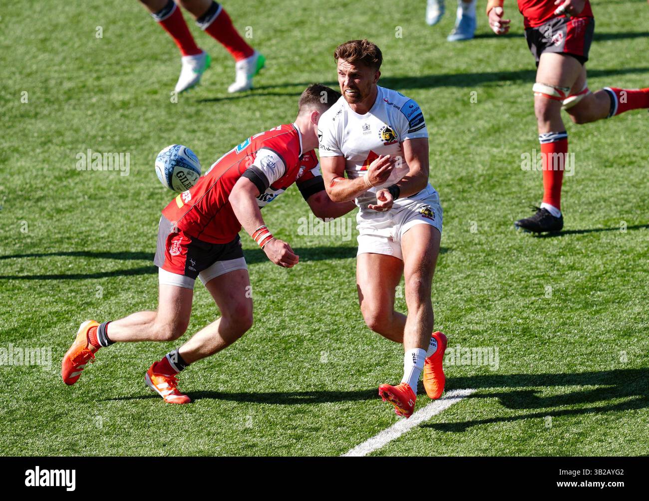 Exeter Chiefs' Henry Slade (right) is tackled by Gloucester's Seb ...