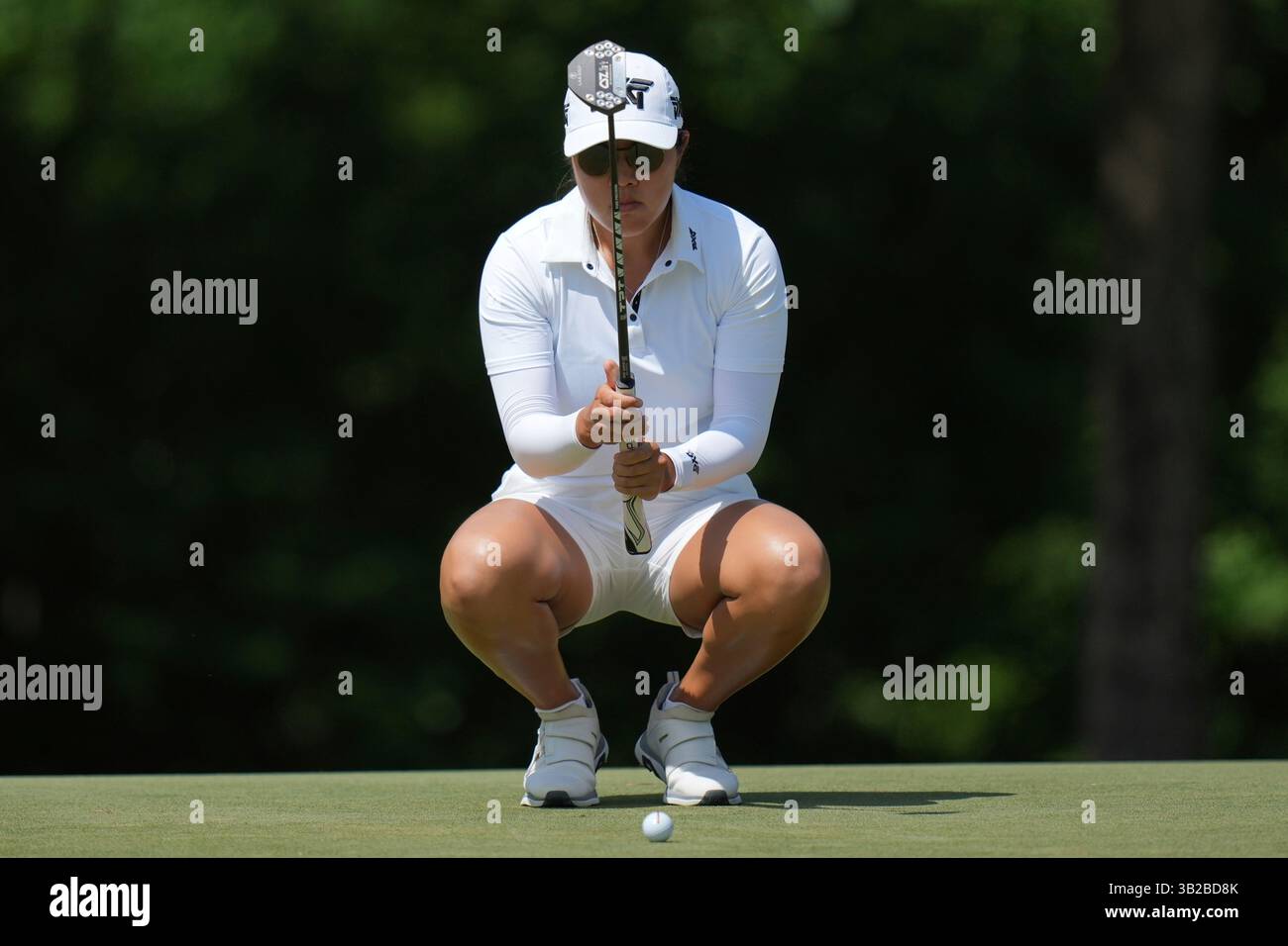 Auston Kim lines up a putt on the first green during the final round of ...