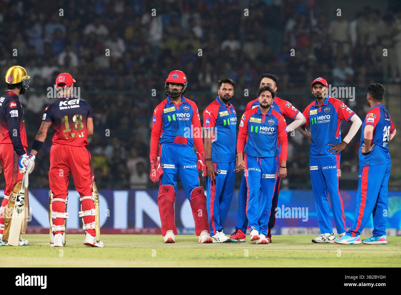 Delhi Capitals' players wait for the third umpire's decision for the ...