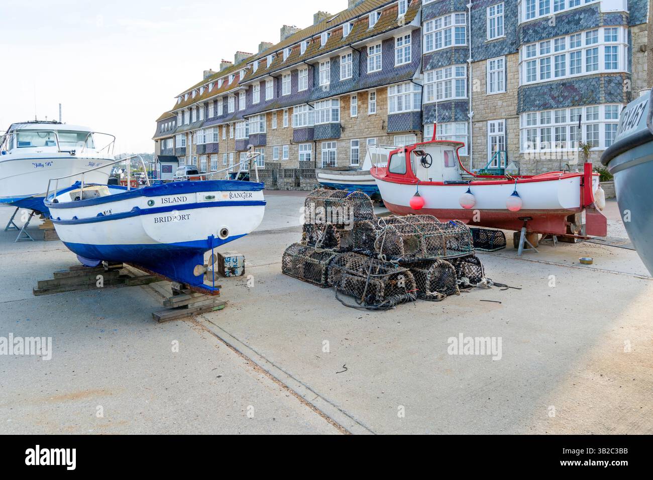 Stack of Lobster pot traps between boats Stock Photo - Alamy