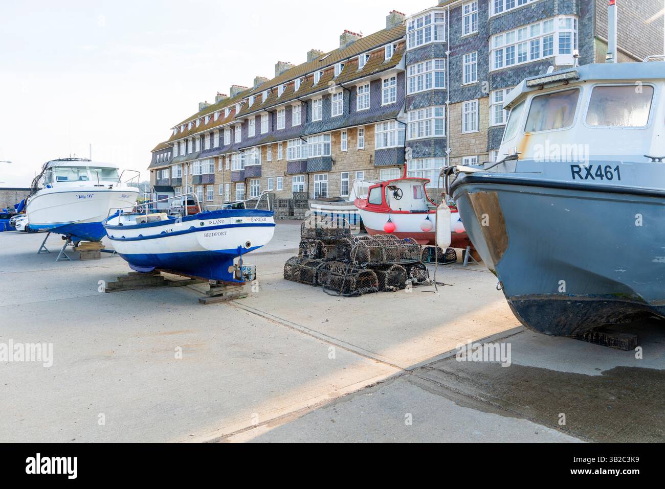 Stack of Lobster pot traps between boats Stock Photo - Alamy