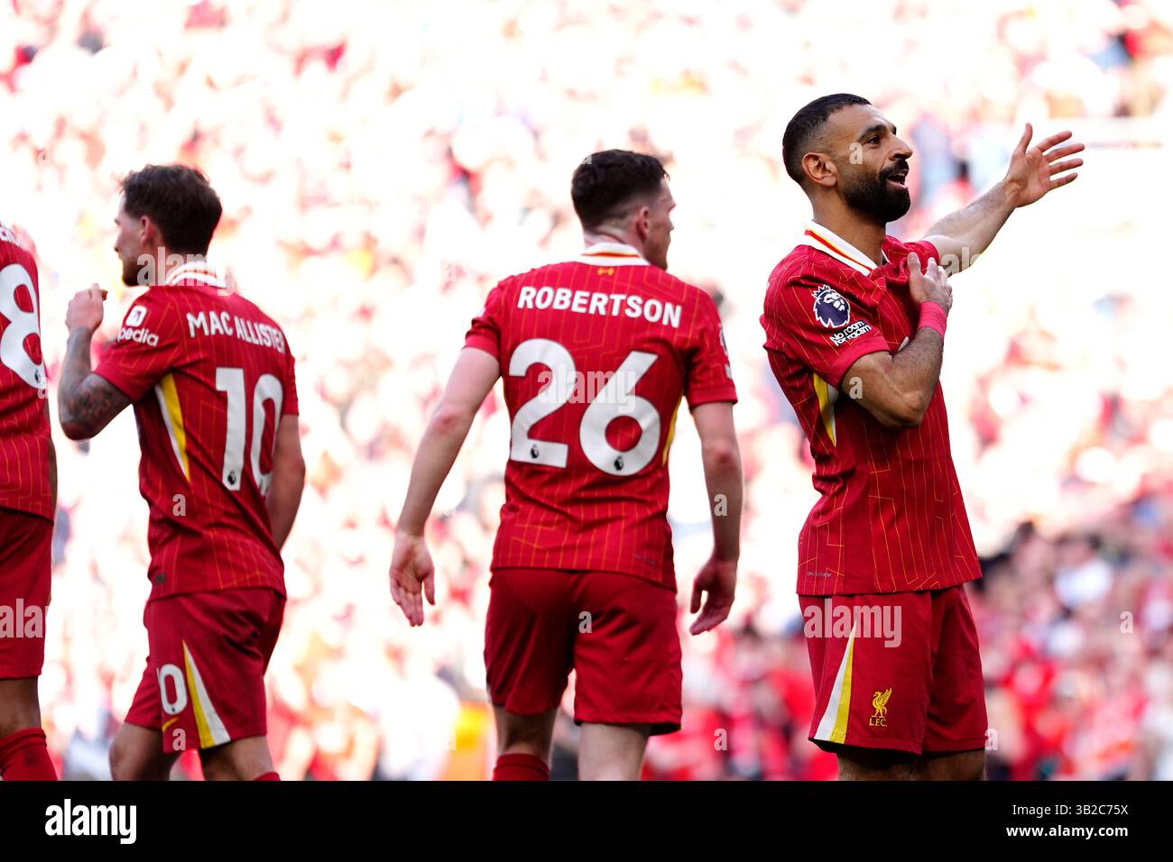 Liverpool's Mohamed Salah (right) celebrates scoring their side's ...