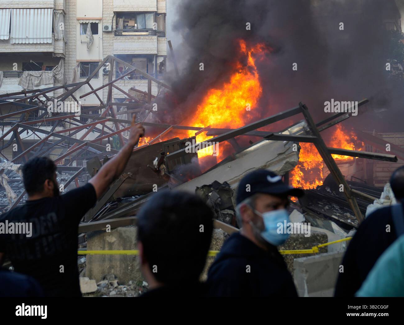 Flames rise from a metal tent that was hit by an Israeli airstrike on ...