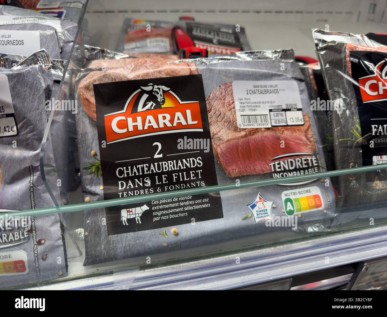 Premium beef cuts showcased in a modern grocery store meat section ...