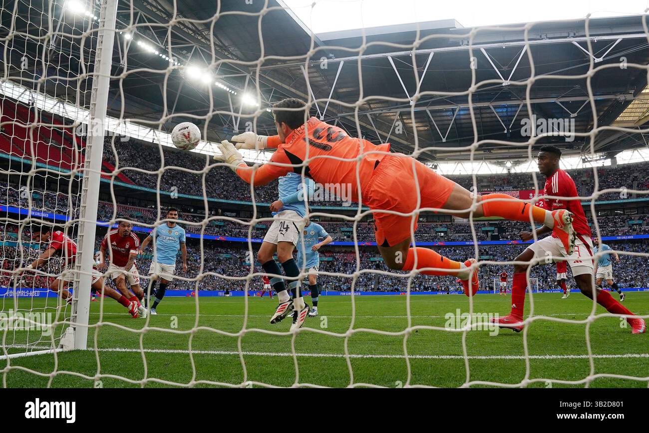 Manchester City goalkeeper Stefan Ortega (centre) makes a save from ...