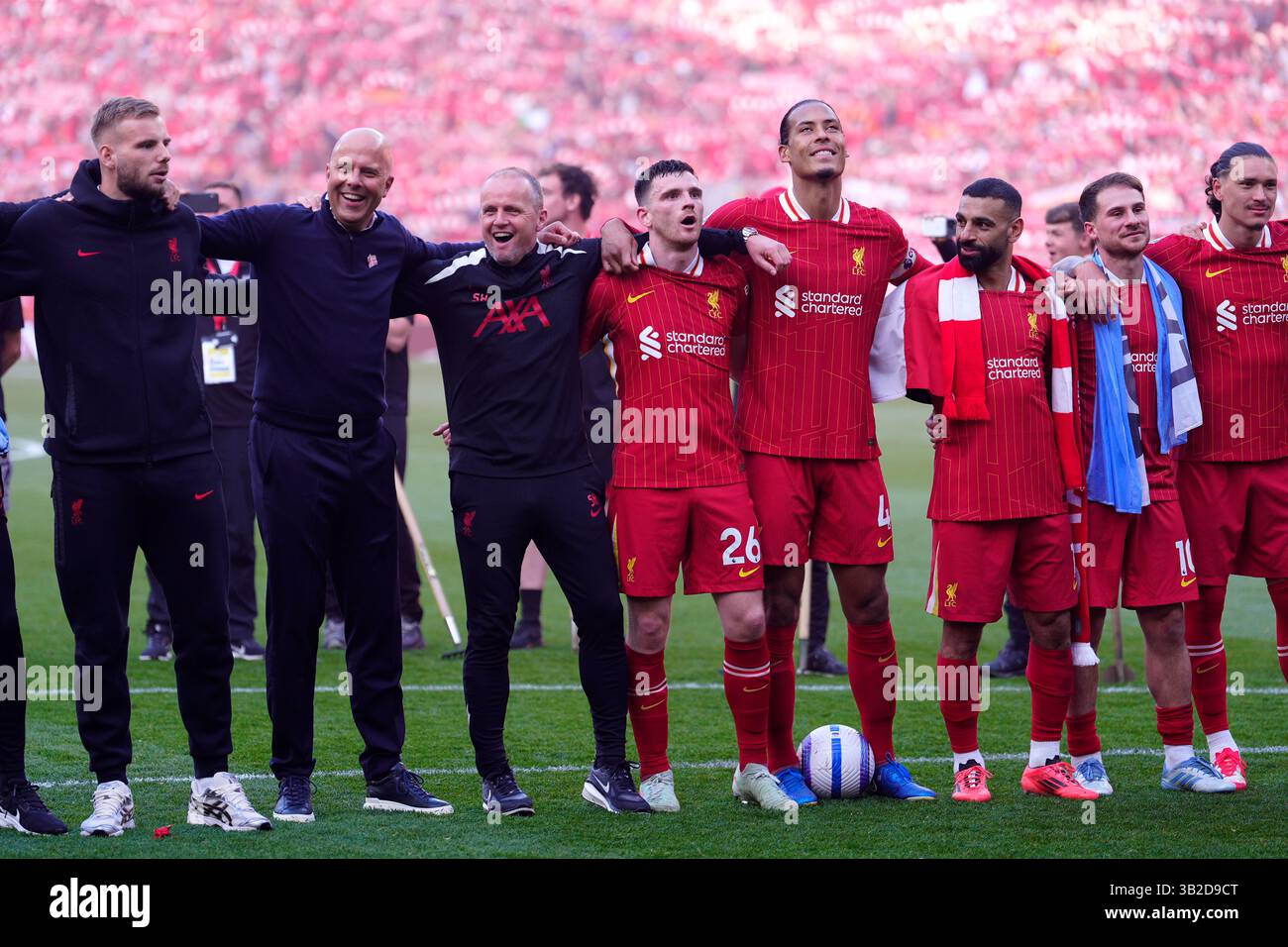 Liverpool players and staff members celebrate victory and the Premier ...