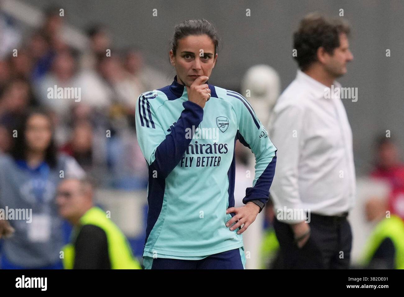 Arsenal coach Renee Slegers and Lyon coach Joe Montemurro, right, stand ...