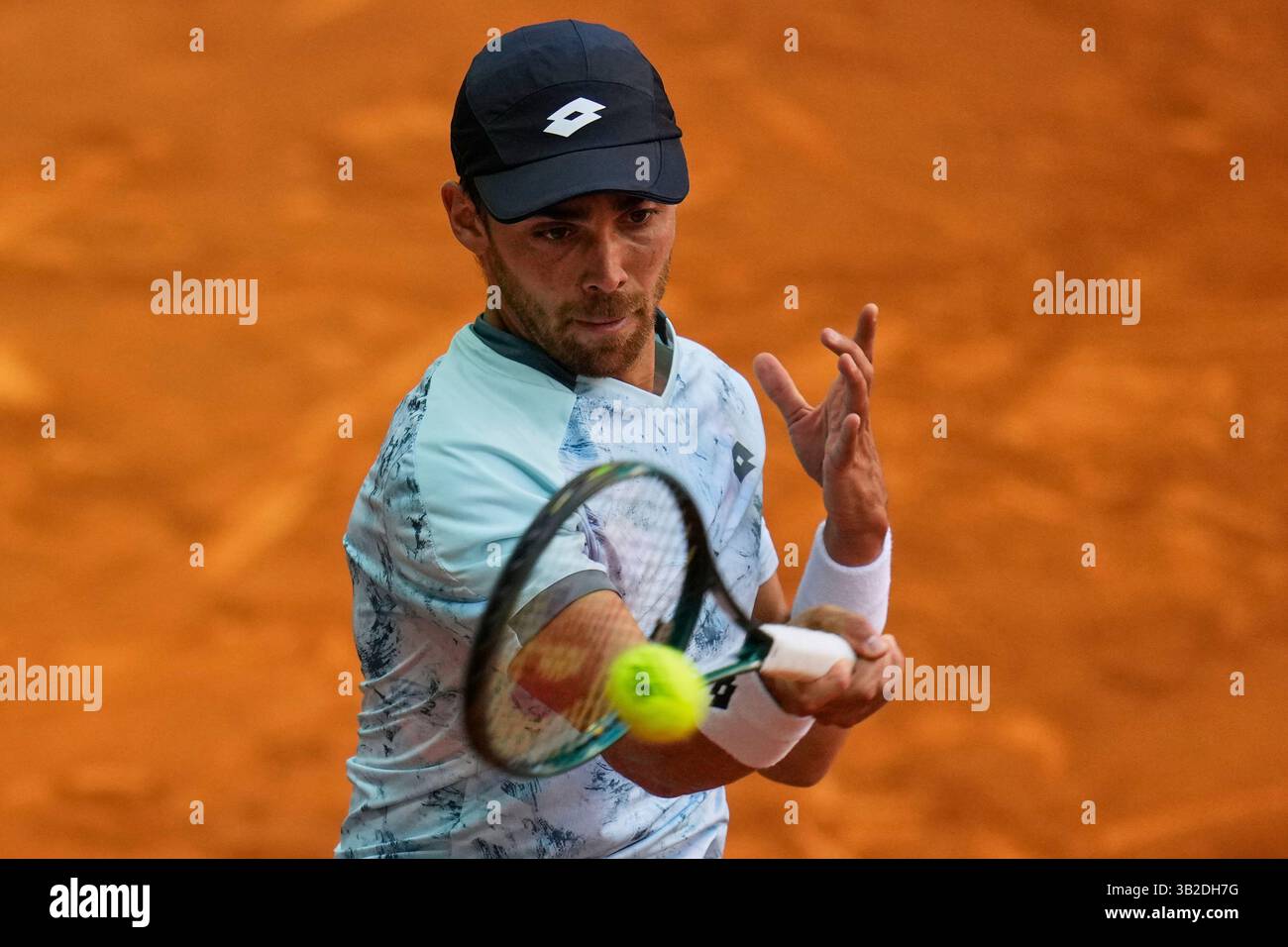 Benjamin Bonzi of France returns the ball during the Madrid Open tennis ...