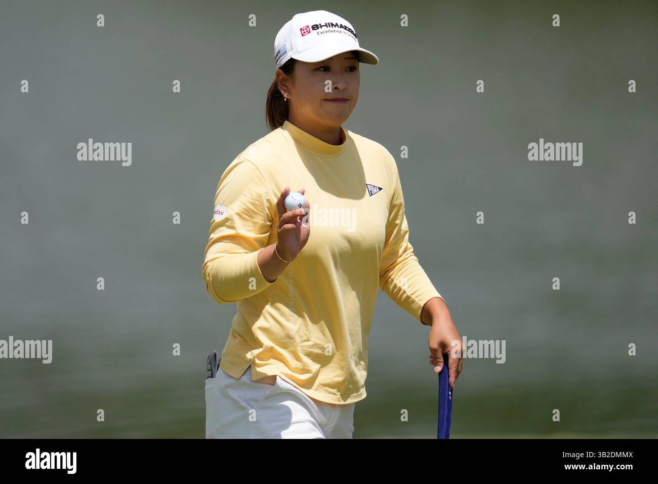 Mao Saigo, of Japan, walks off gthe third green during the final round ...