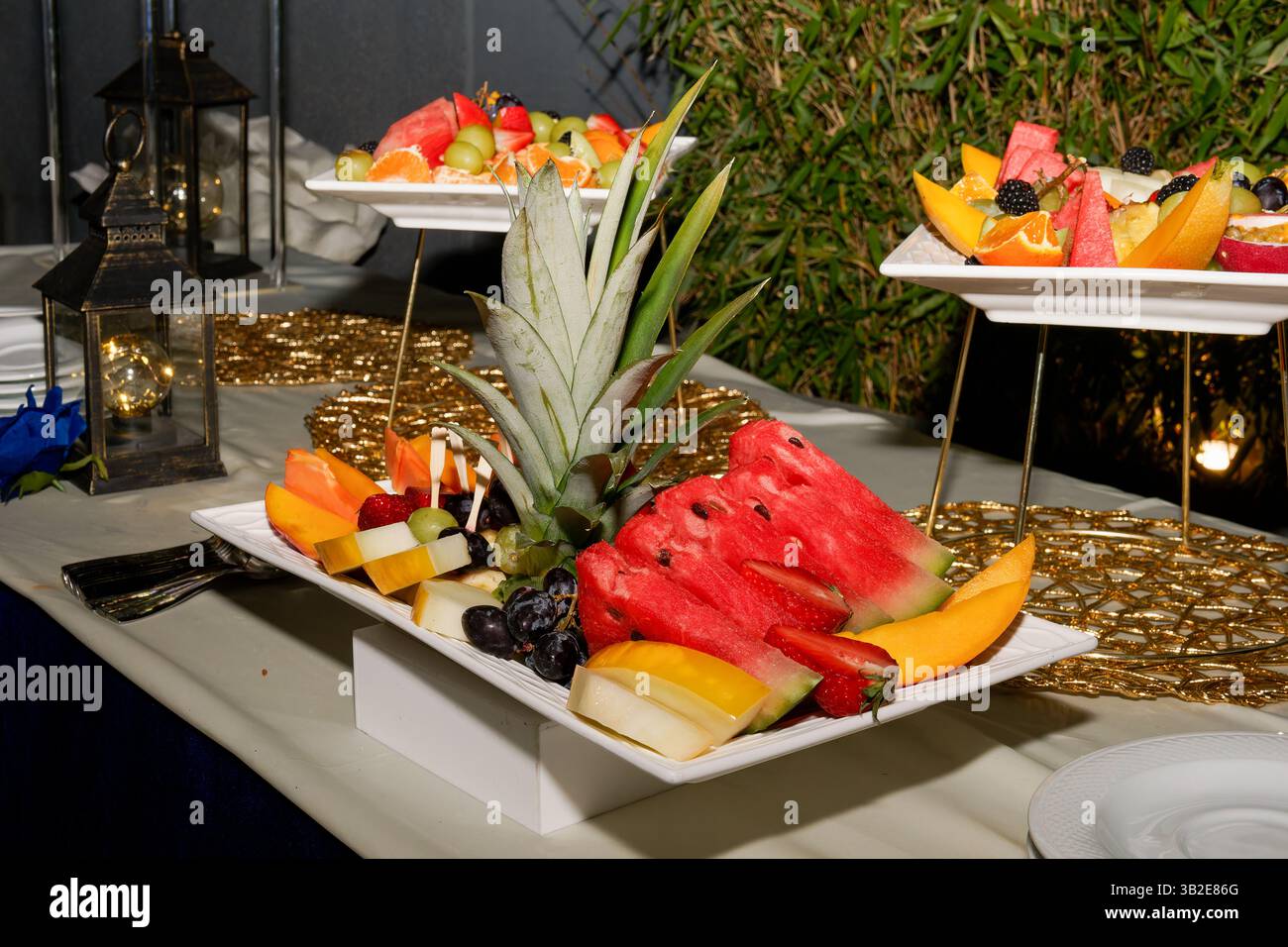 Colorful cut fruit platter on buffet table at outdoor birthday party ...