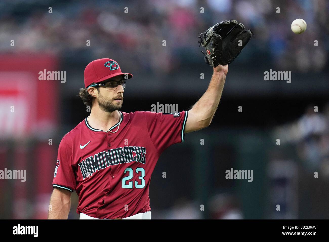 Arizona Diamondbacks starting pitcher Zac Gallen reaches for a new ball ...