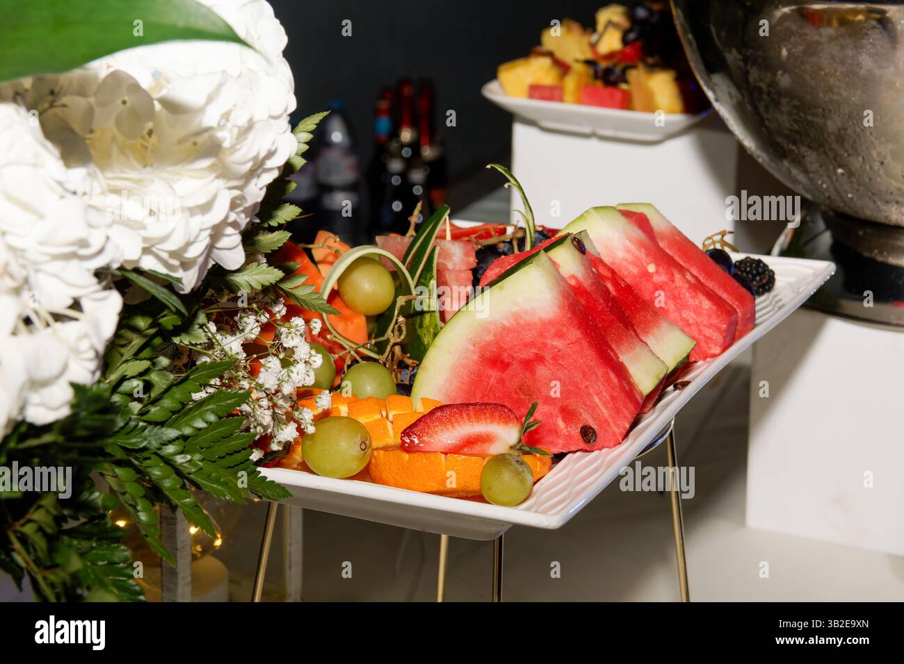 Colorful cut fruit platter on buffet table at outdoor birthday party ...