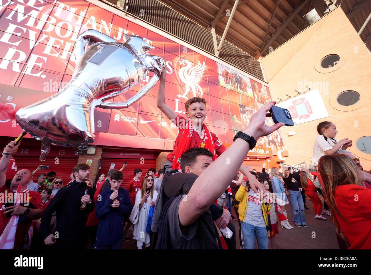 Liverpool fans celebrate victory in the Premier League outside Anfield ...