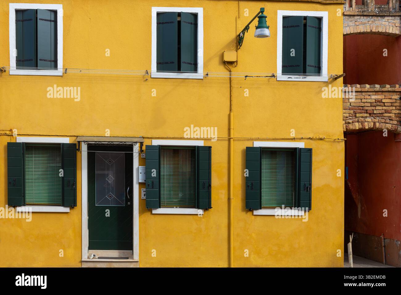 Yellow Facade with Green Shuttered Windows and Door Stock Photo - Alamy