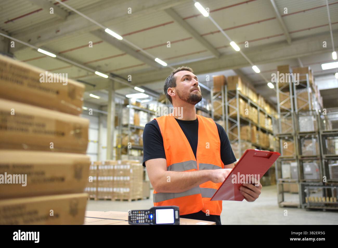friendly warehouse worker in a warehouse with the barcode scanner Stock ...