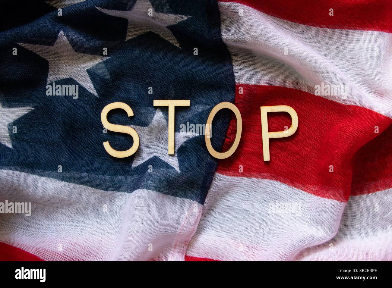 Wooden letters forming the word STOP on the background of the US flag ...