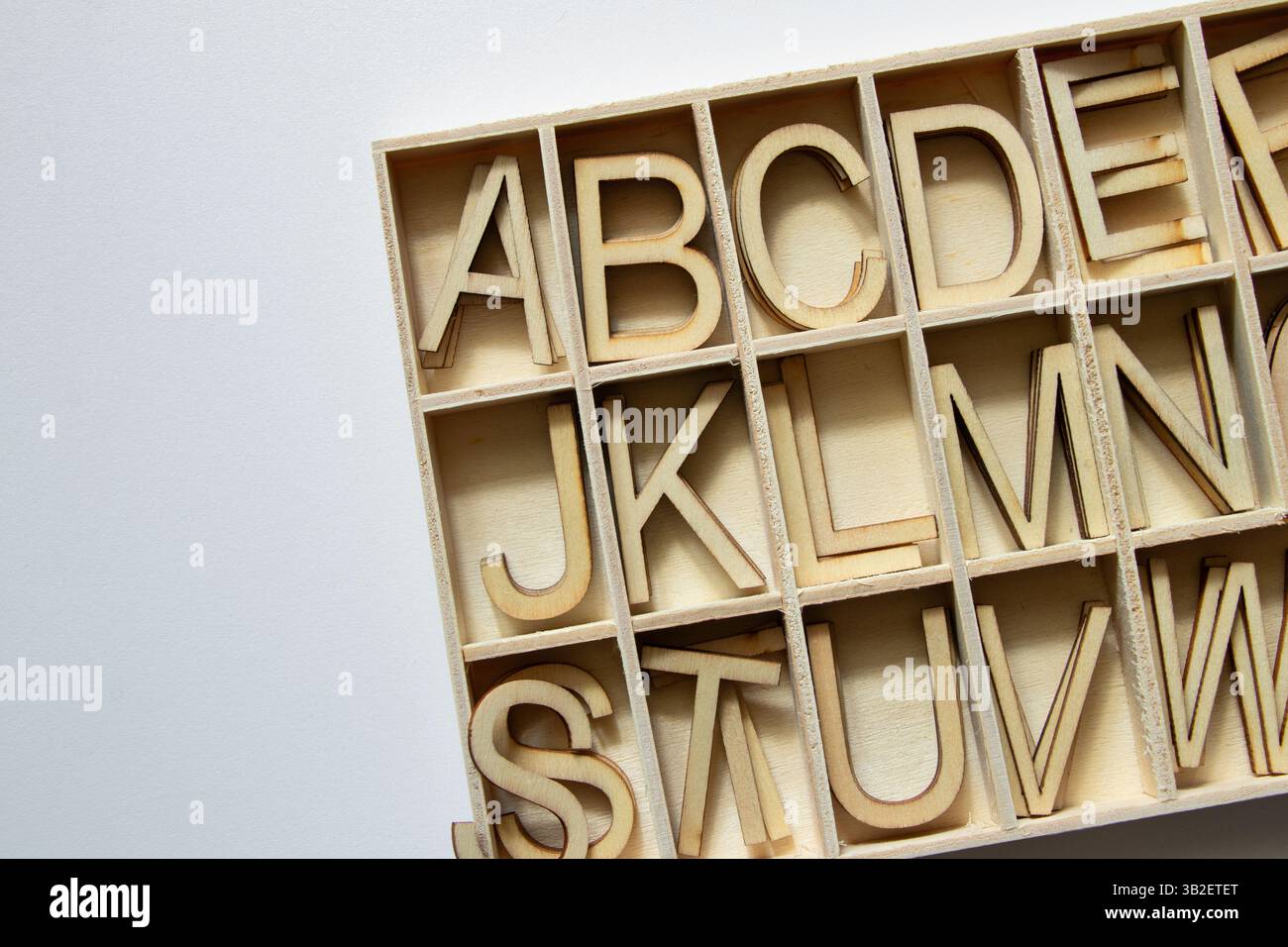 Wooden English alphabet letters arranged in cells, alphabet letters in ...