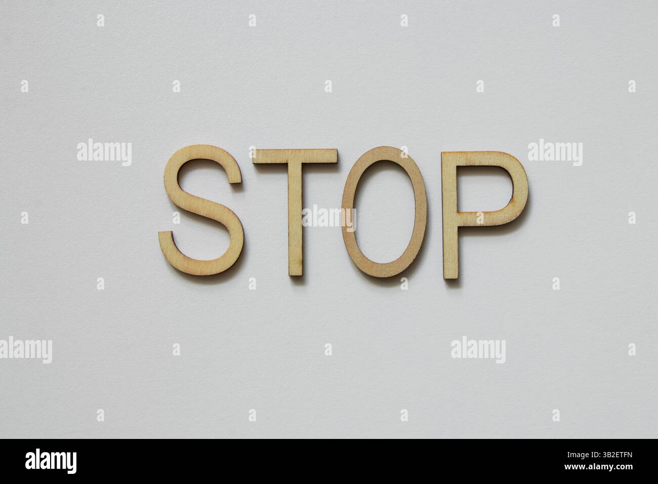 Wooden letters forming the word stop on a white background,word stop ...