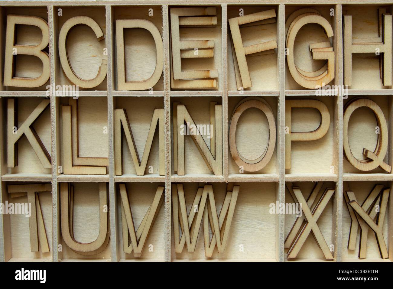 Wooden English alphabet letters arranged in cells, alphabet letters in ...