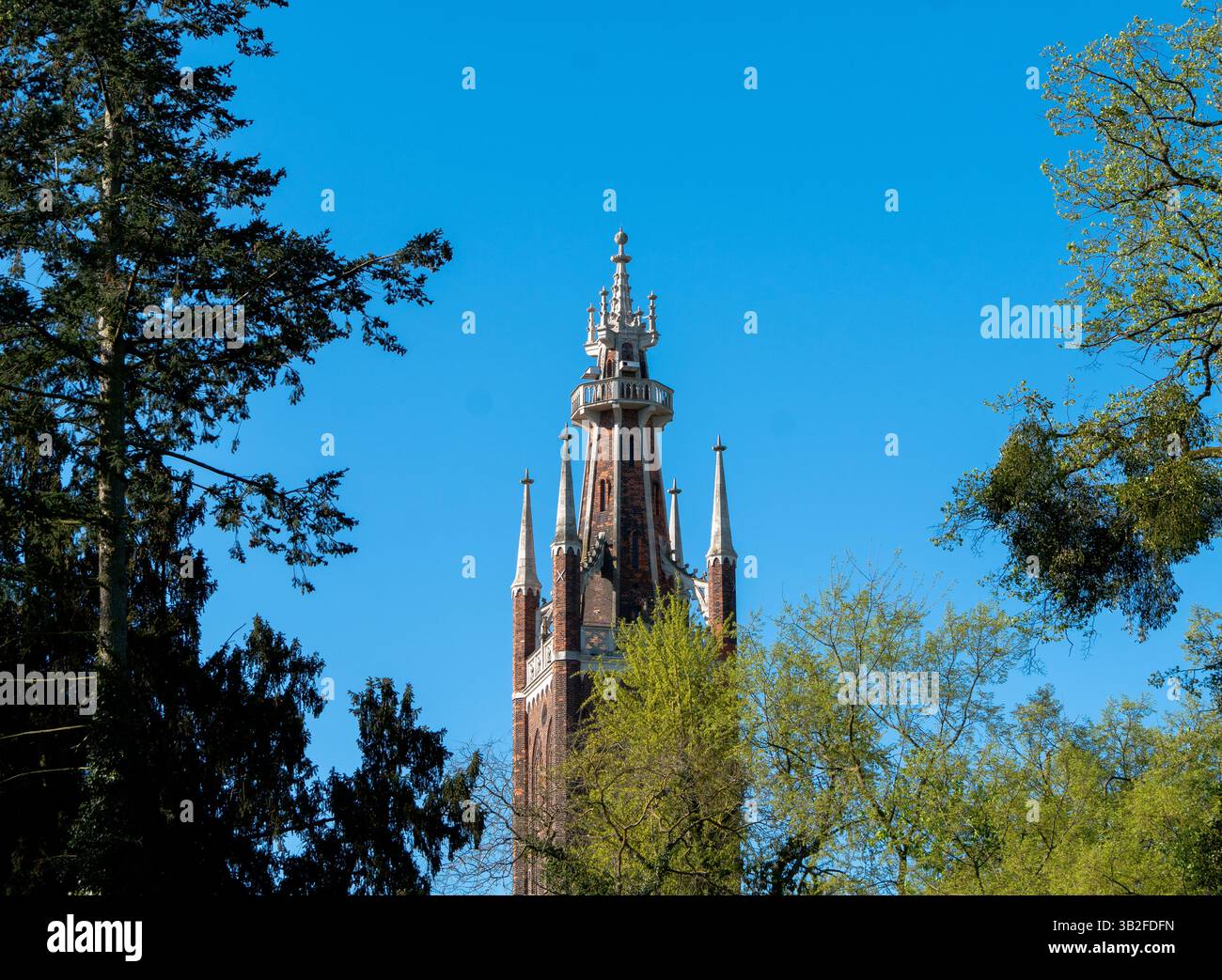 Gothic tower in Werlicky Park, neo-Gothic architecture among greenery ...