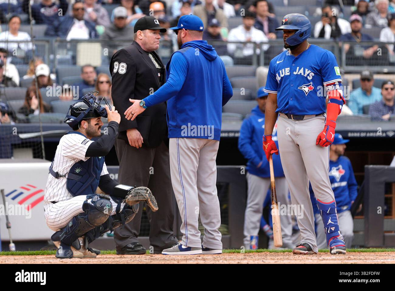 Toronto Blue Jays manager John Schneider, center, speaks to umpire ...