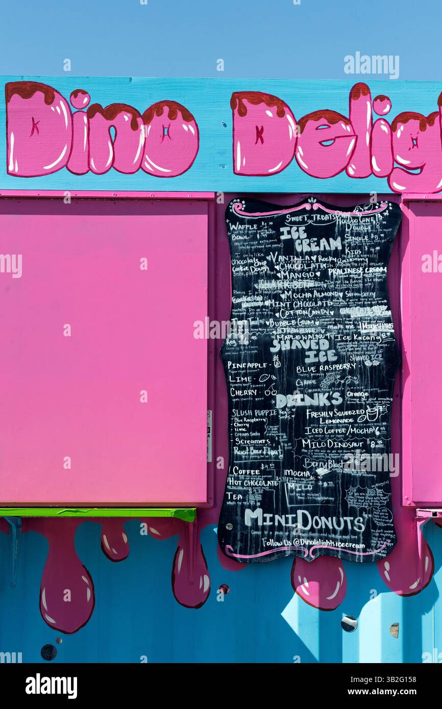 Colorful Dino Delights concession stand with bright pink facade and ...