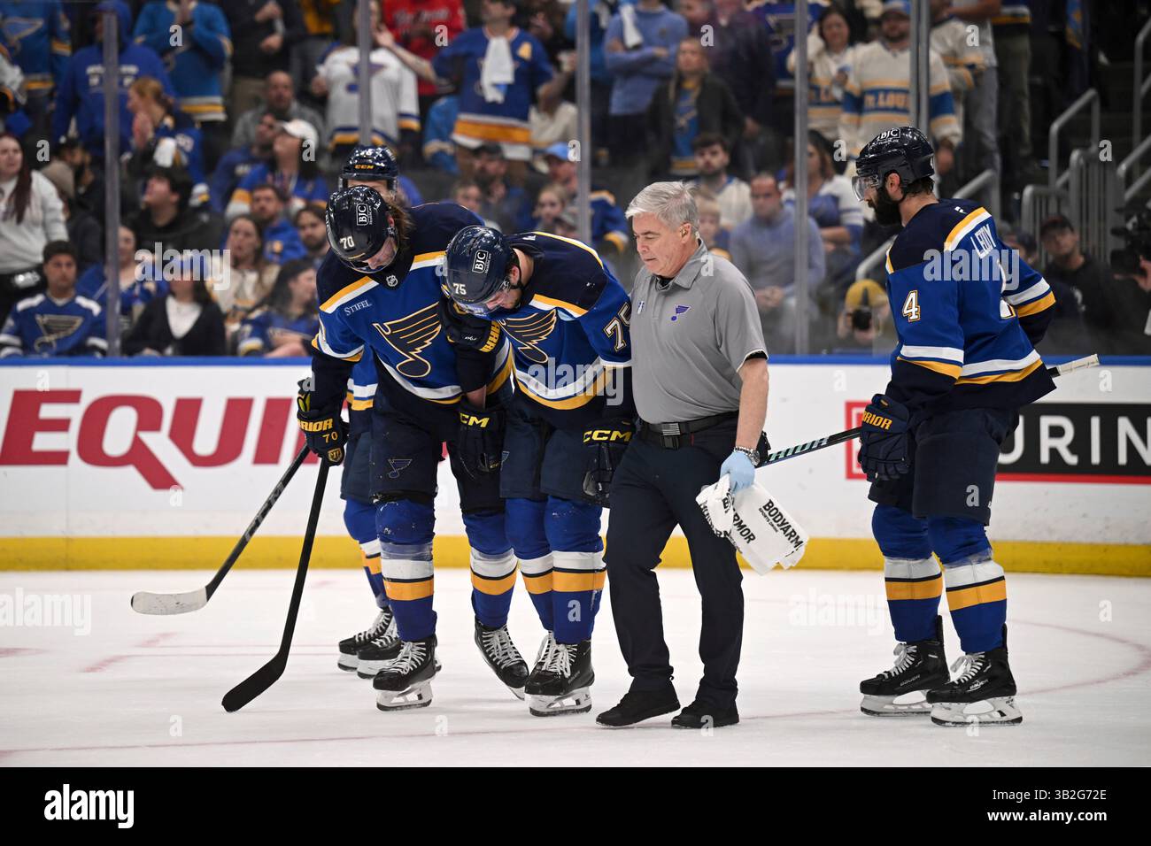 St. Louis Blues' Tyler Tucker (75) is assisted off the ice after being ...