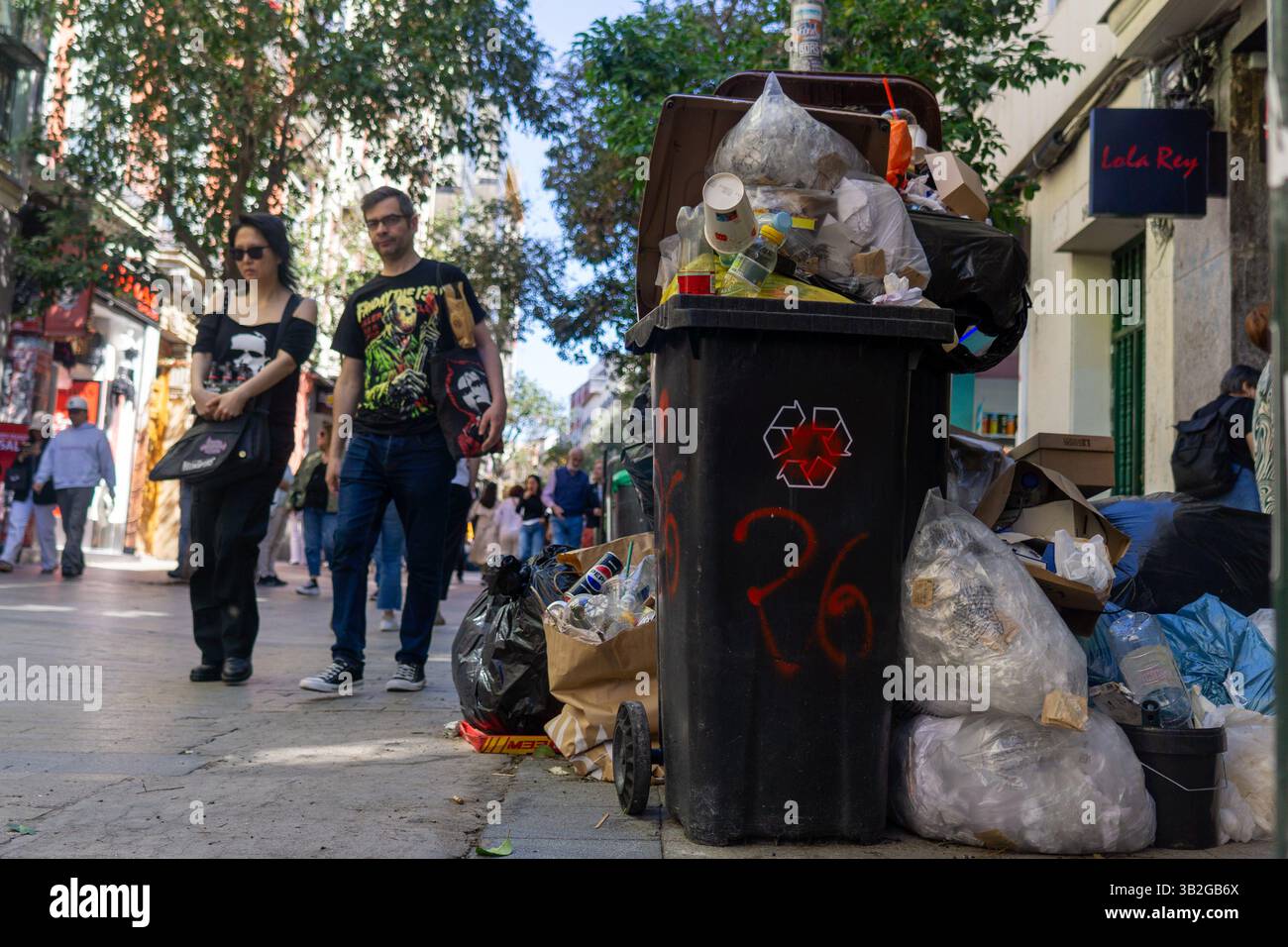 Madrid, Spain. 27th Apr, 2025. A couple walks down a street next to ...