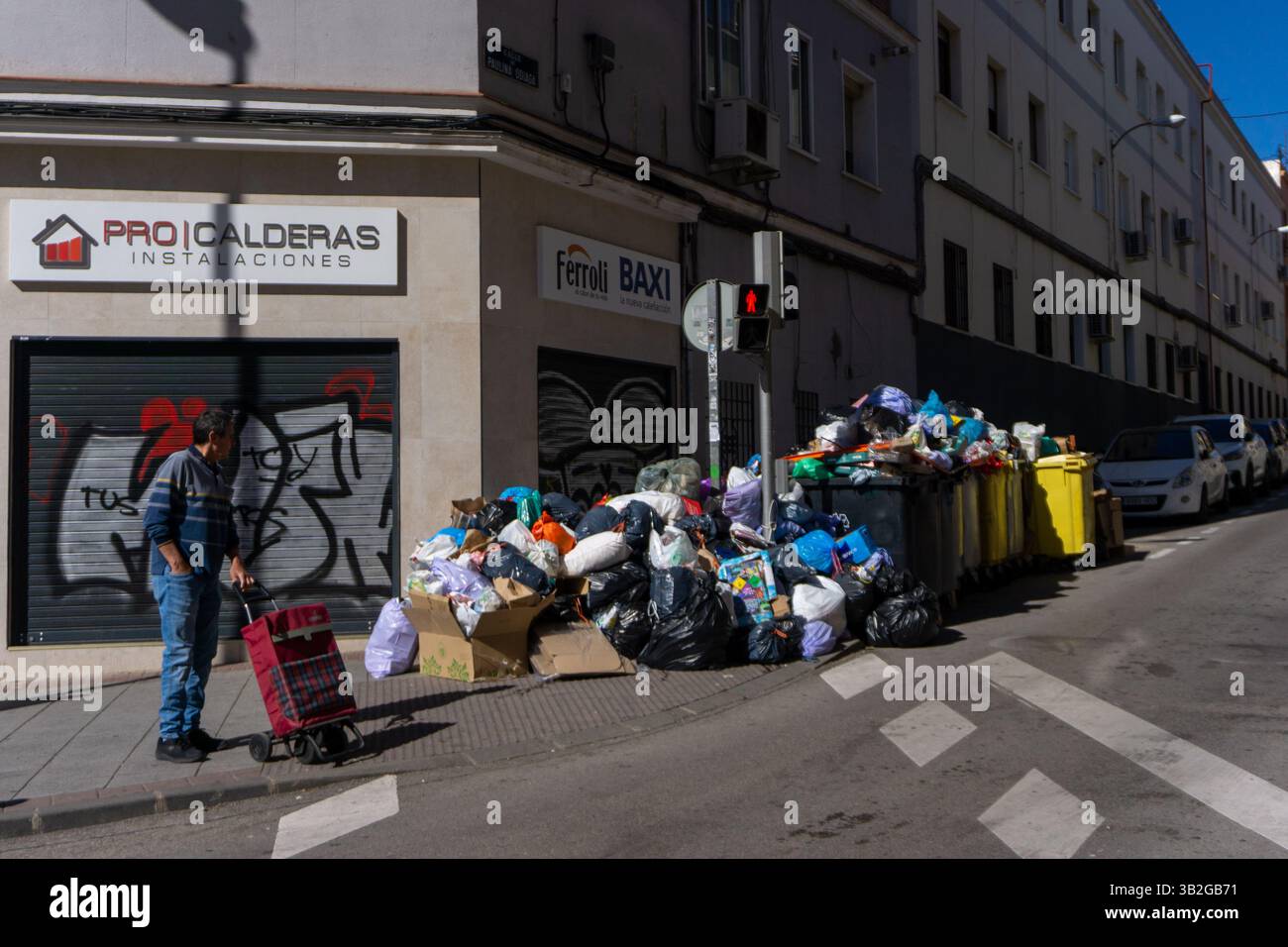 Madrid, Spain. 27th Apr, 2025. Several bins overflowing with garbage on ...