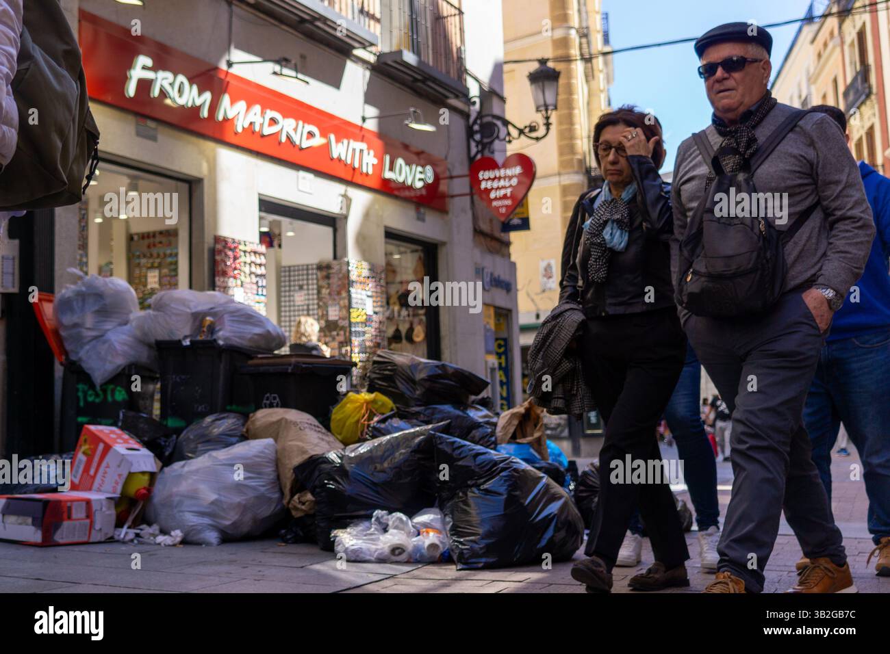 Madrid, Spain. 27th Apr, 2025. A couple walks down a street next to ...