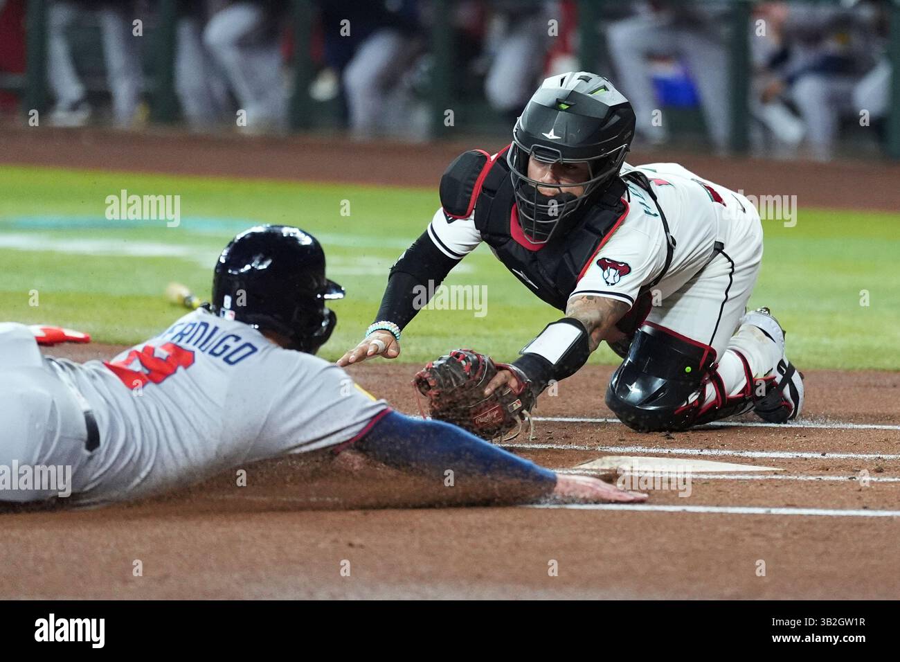 Arizona Diamondbacks catcher Jose Herrera, right, reaches over to tag ...