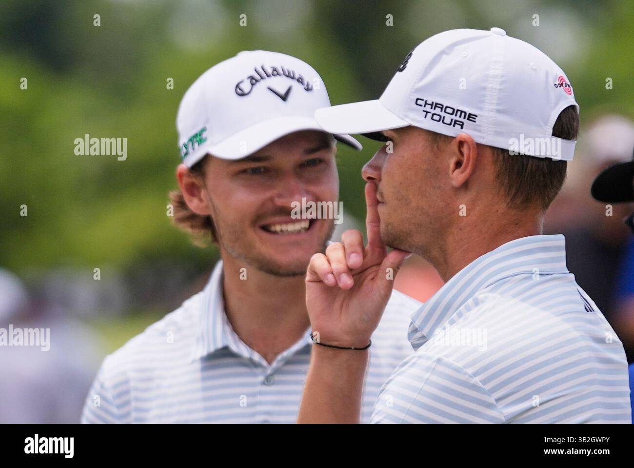 Rasmus Hojgaard, of Denmark, talks with his twin brother and teammate ...