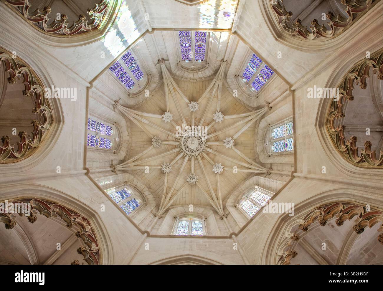 Intricate ceiling and beautiful stained glass windows of Batalha ...