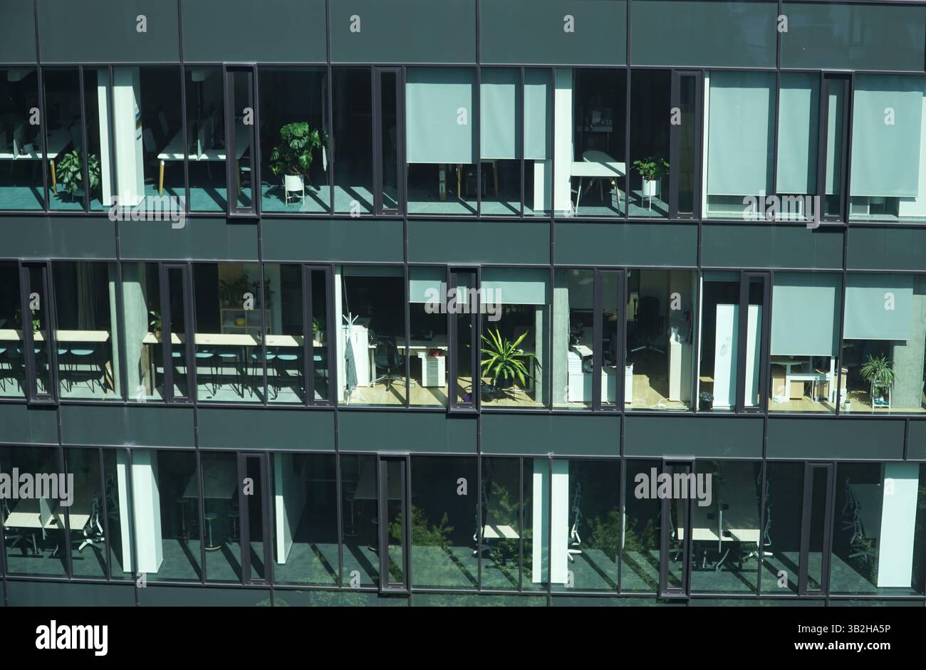 A view of a modern office building , with workspaces visible through ...
