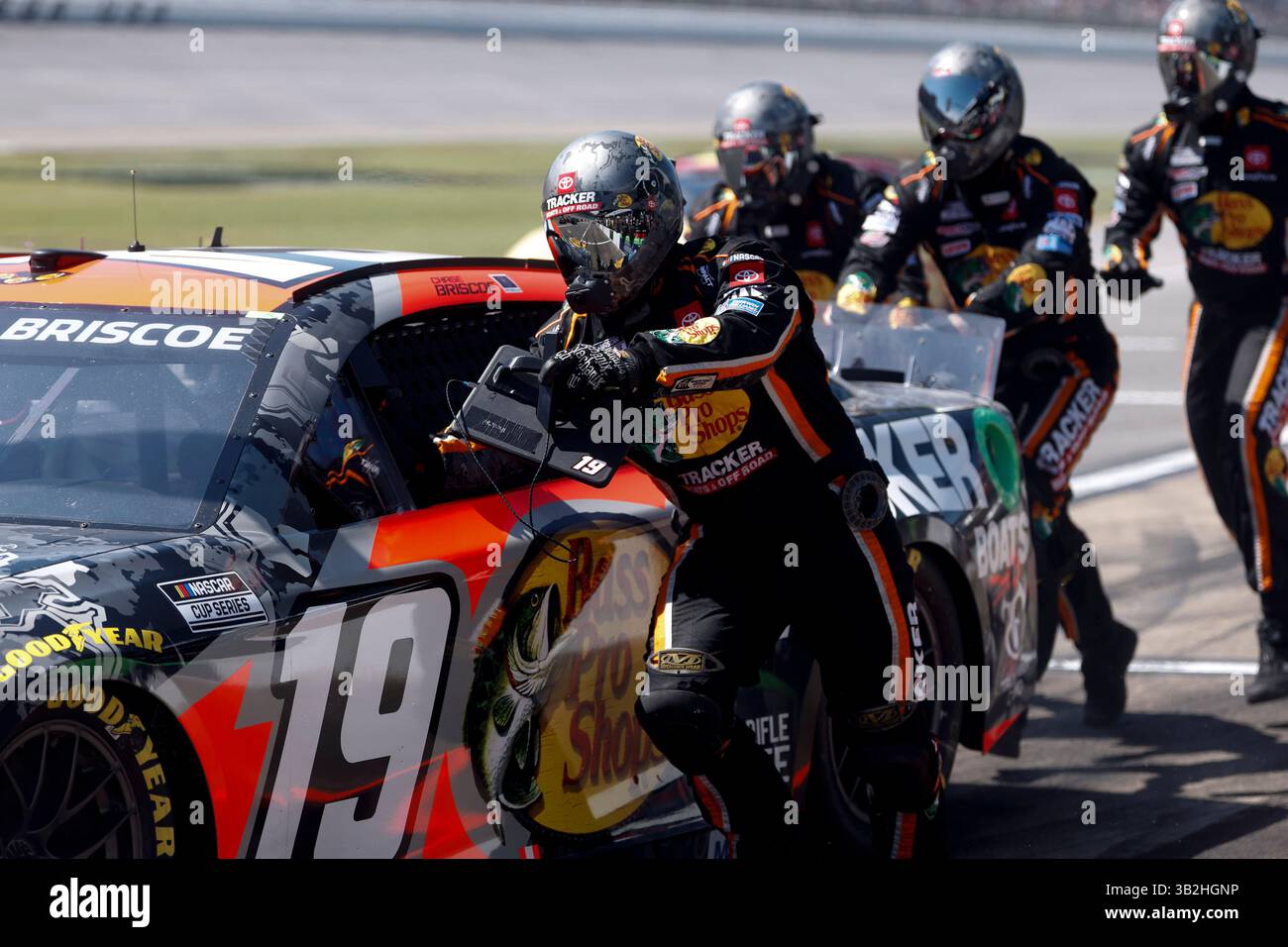 Crew members of Chase Briscoe push his car to get it started after a ...