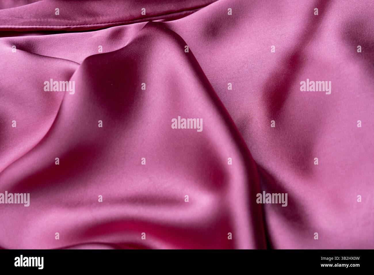 A light pink silky fabric that exudes elegance and grace, offering a ...