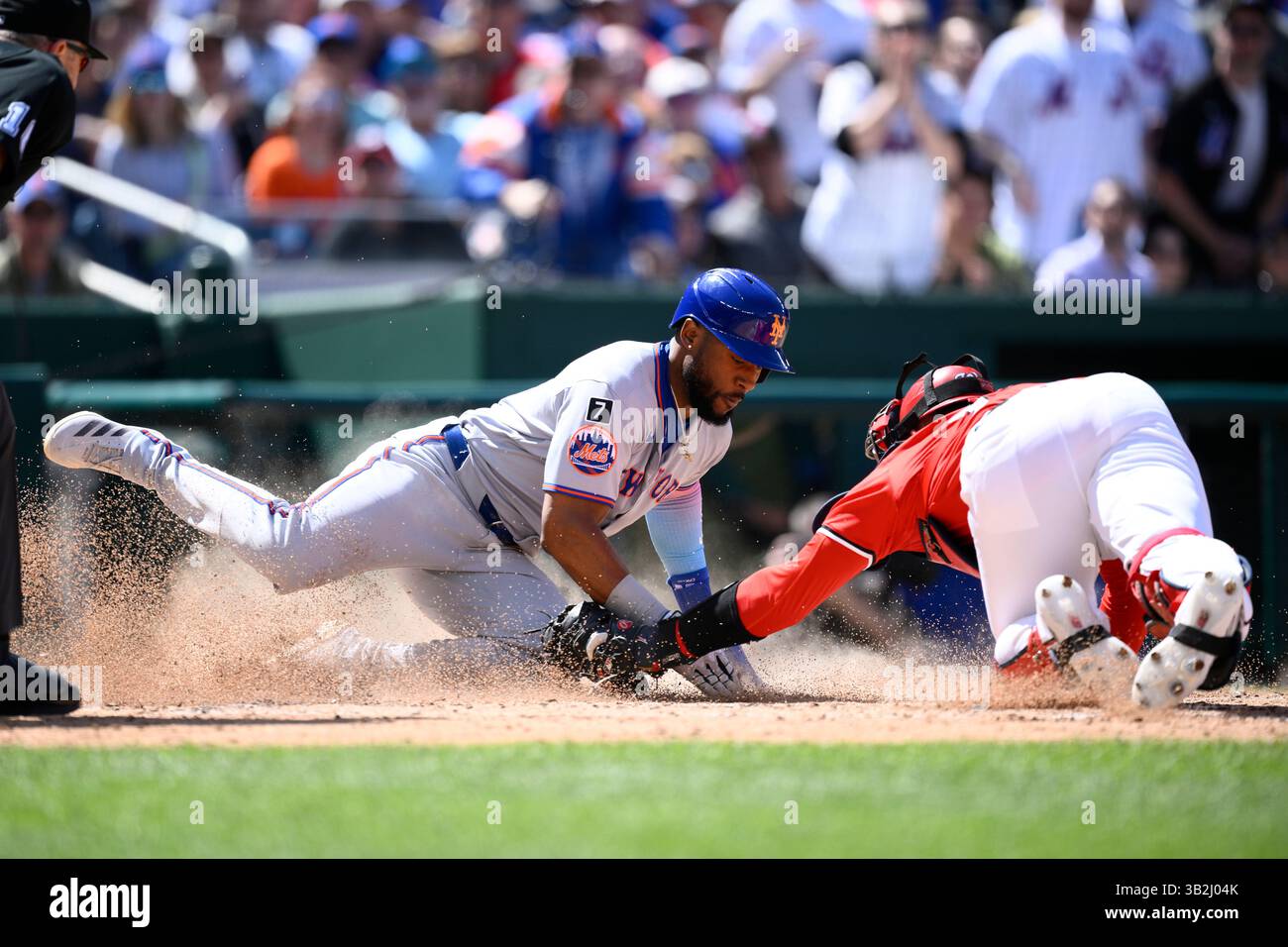 New York Mets' Starling Marte, left, slides home to score against ...