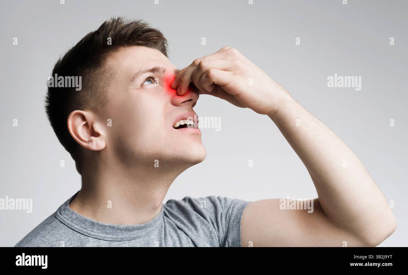 Young man touching bleeding hi-res stock photography and images - Alamy