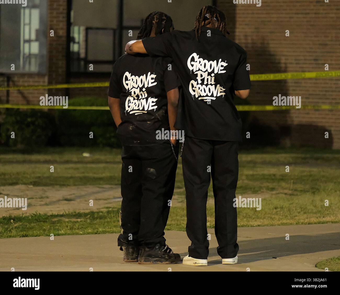 Two young men console each other outside the Bedell Hall campus ...