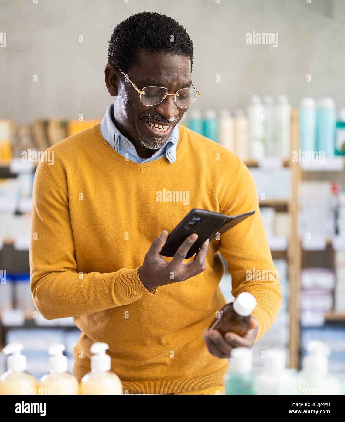 Adult man scanning qr code of syrup Stock Photo - Alamy