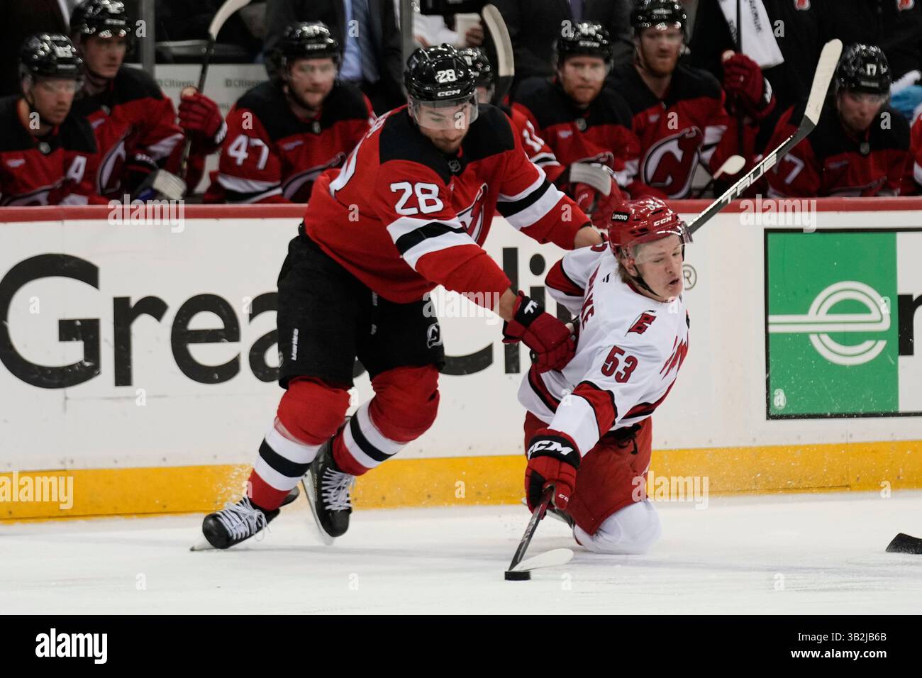 New Jersey Devils' Timo Meier, left, pushes Carolina Hurricanes ...